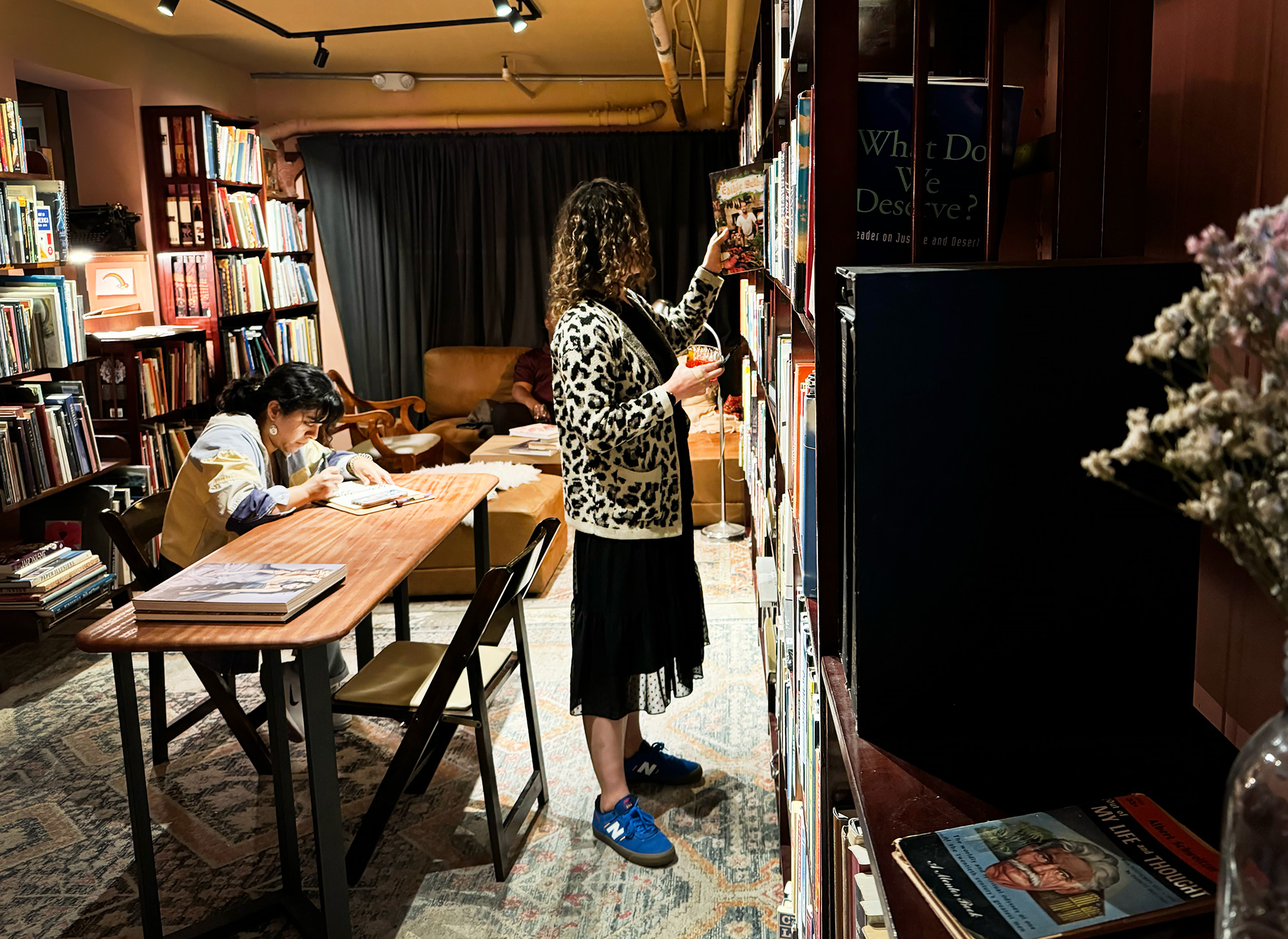 At this Oakland basement bookstore, customers browse with cocktails in hand